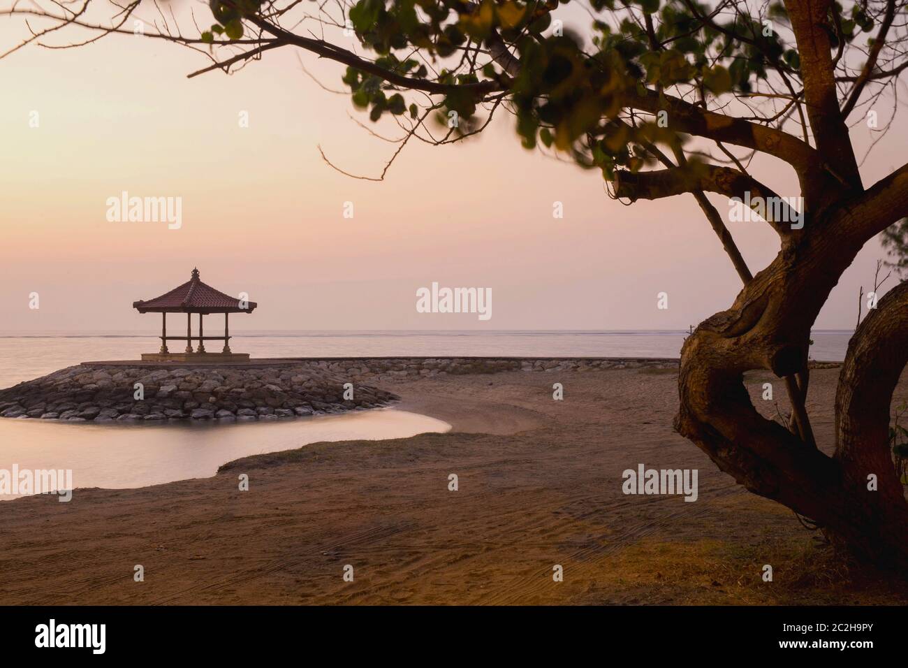 Landscape in Bali colorful sunrise at the beach Sanur, with rest hut ...