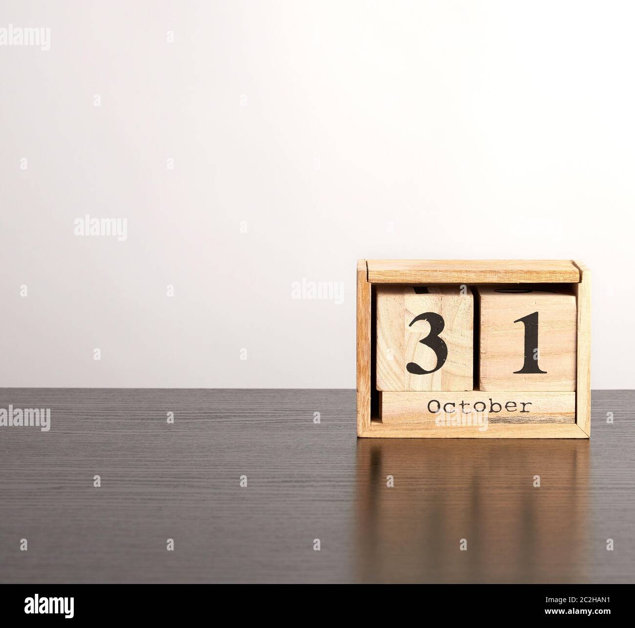 wooden calendar of cubes with the date October 31 on a black table ...