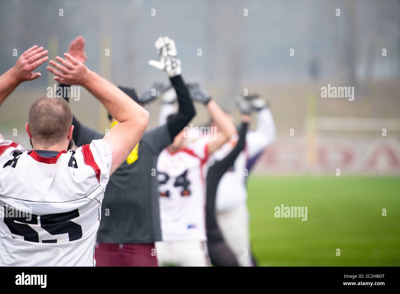 american football players stretching and warming up Stock Photo - Alamy