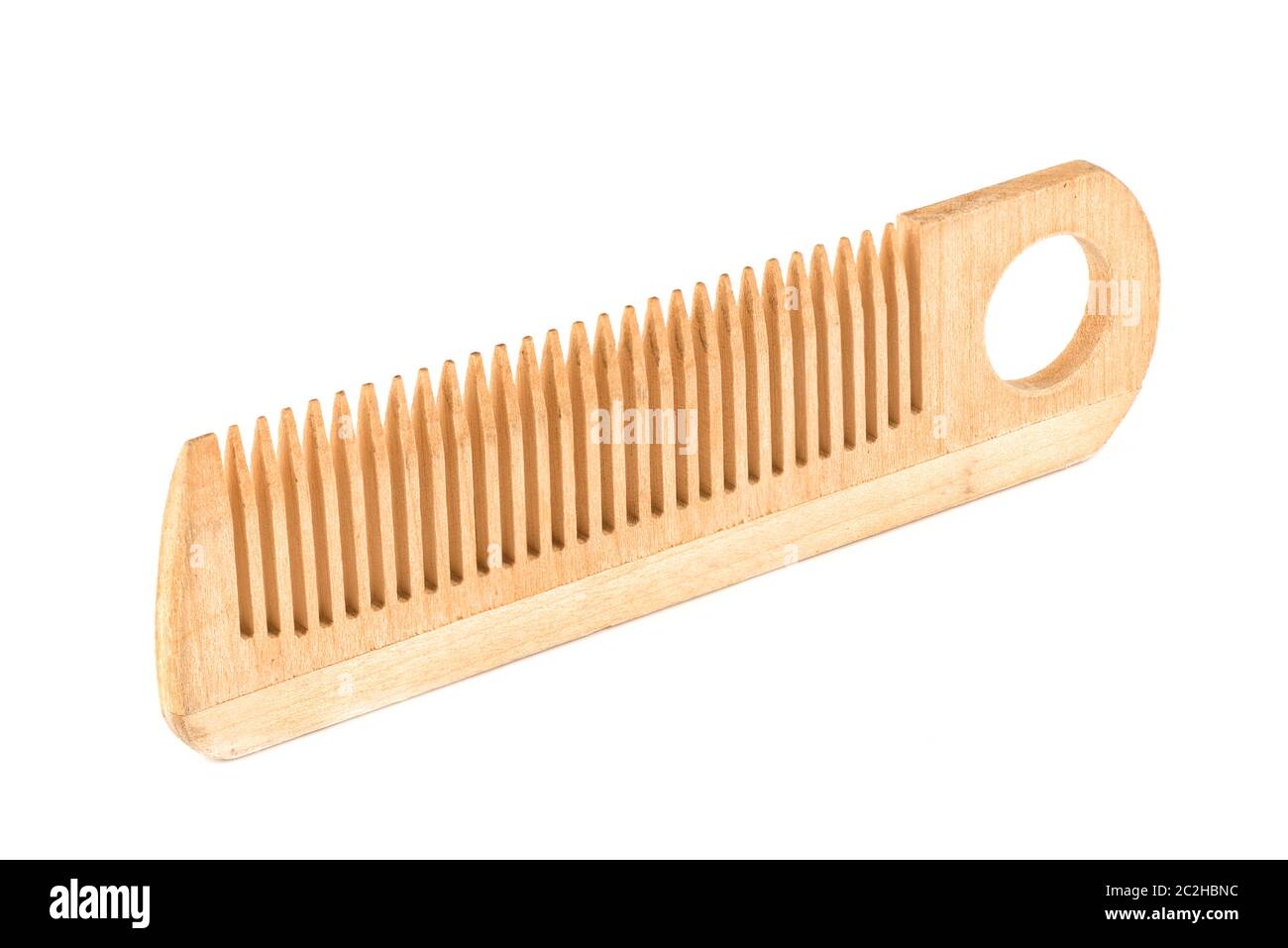 Wooden comb stands on a white background. Copy space Stock Photo - Alamy