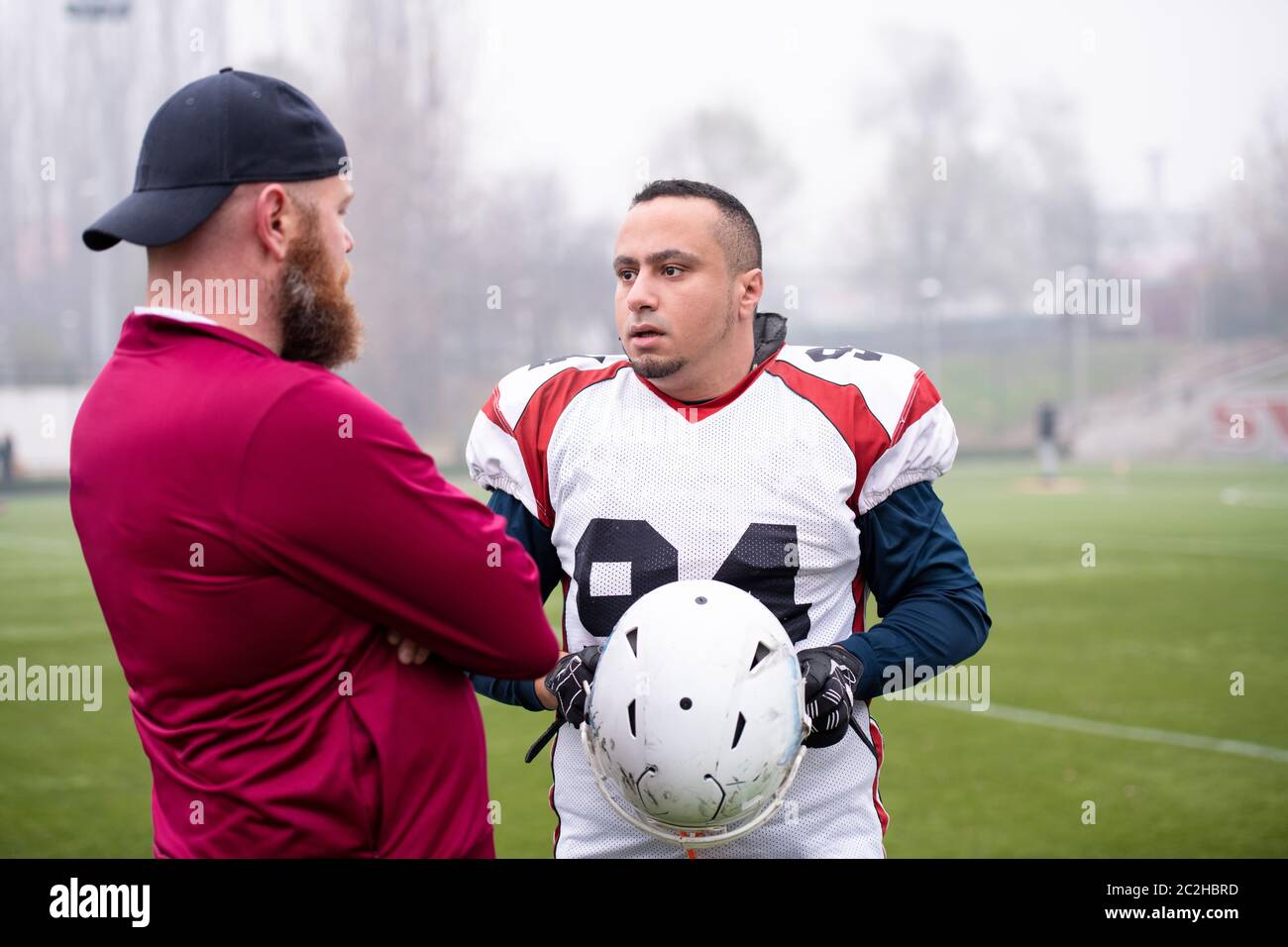 american football player discussing strategy with coach Stock Photo - Alamy