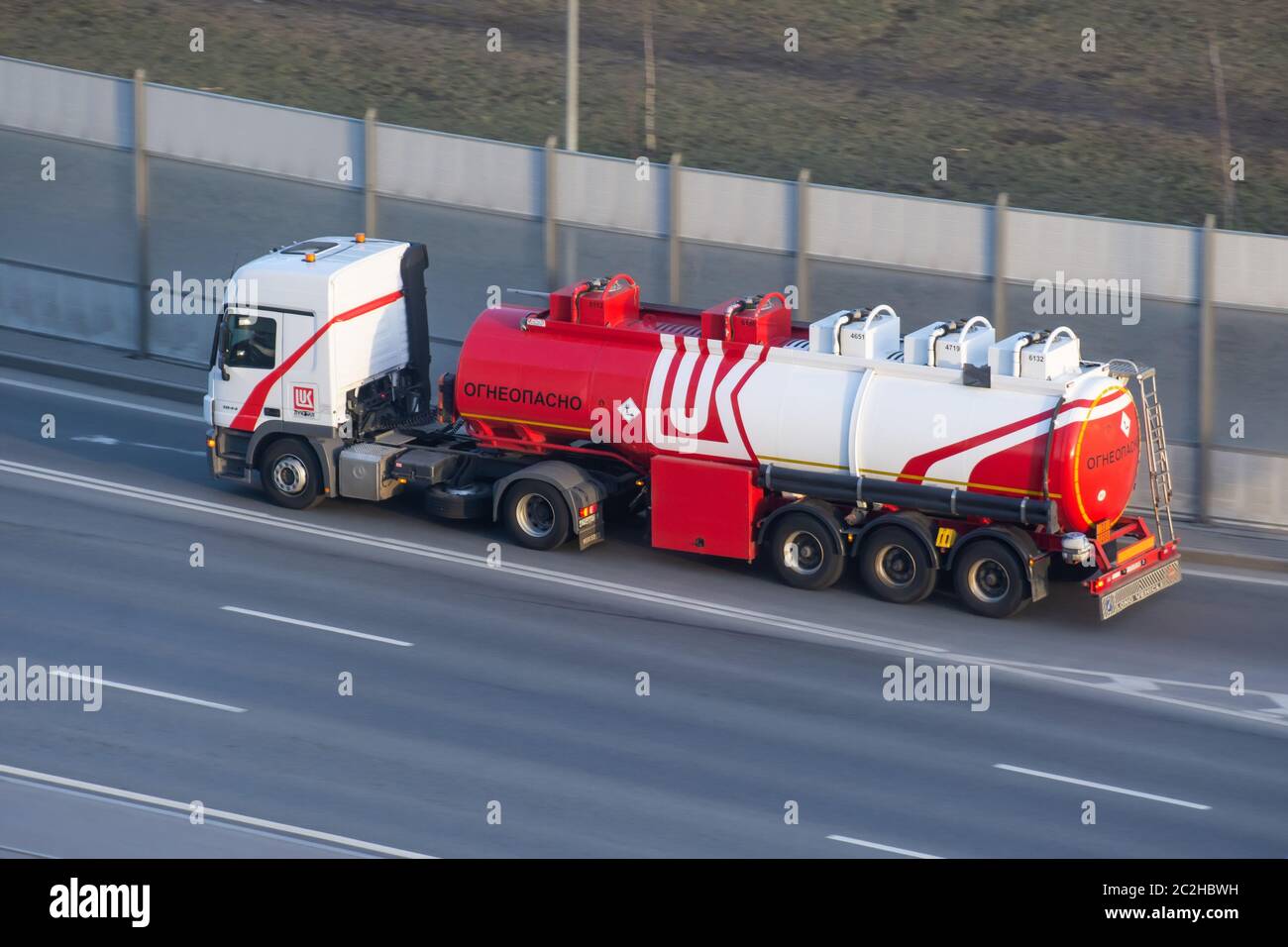 Heavy big fuel tanker with shiny metal lame tank driving on city ...