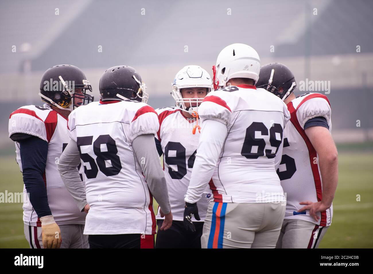 american football players discussing strategy Stock Photo - Alamy