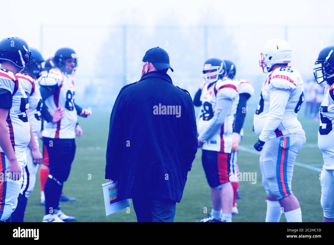 american football players discussing strategy with coach Stock Photo ...