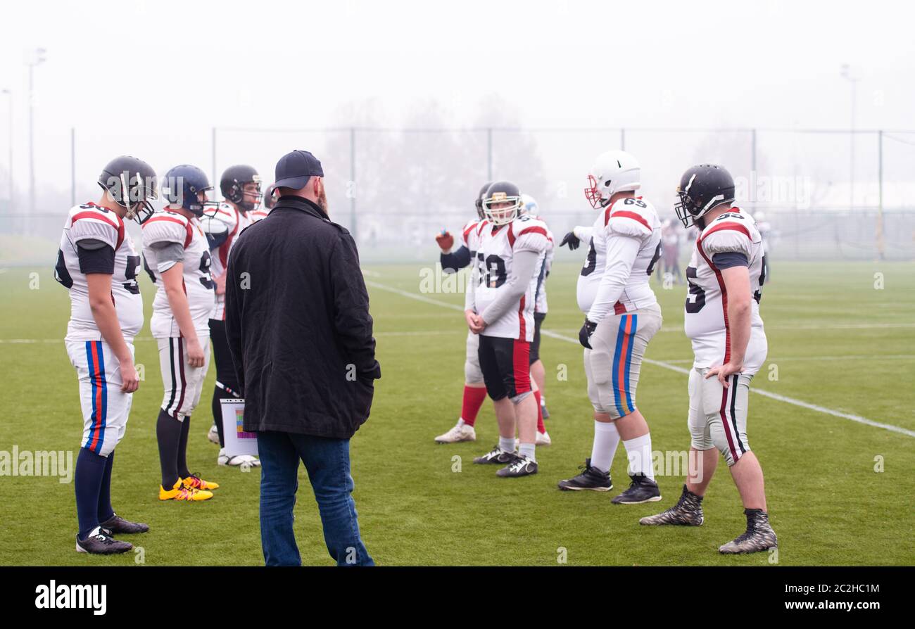 american football players discussing strategy with coach Stock Photo ...