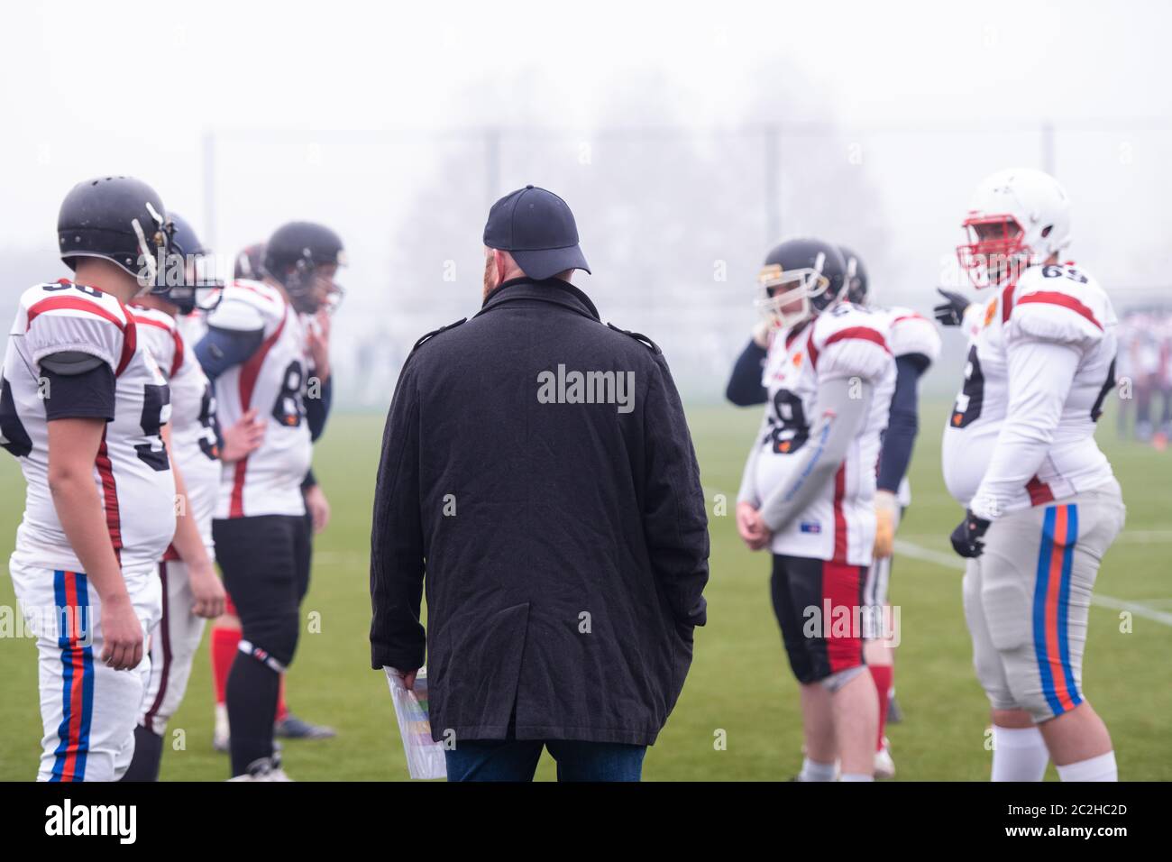 american football players discussing strategy with coach Stock Photo ...