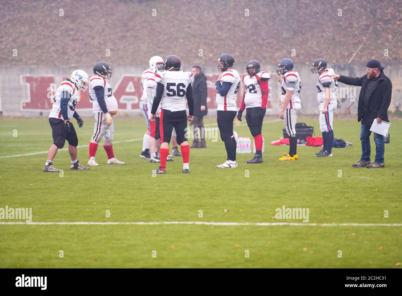 american football players discussing strategy with coach Stock Photo ...