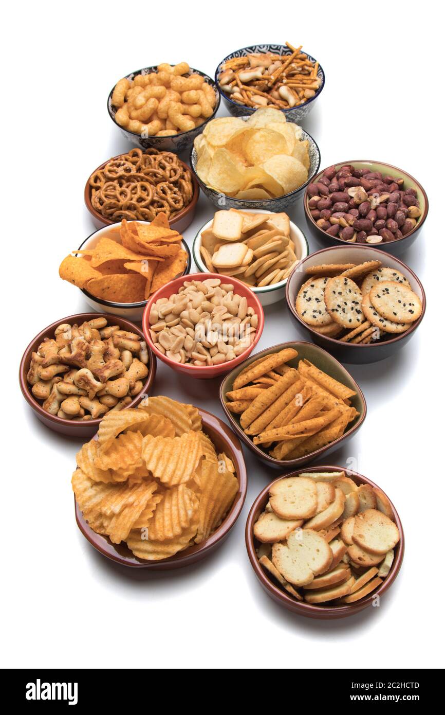 Pretzels, potato chips, crackers and other salty snacks isolated on ...