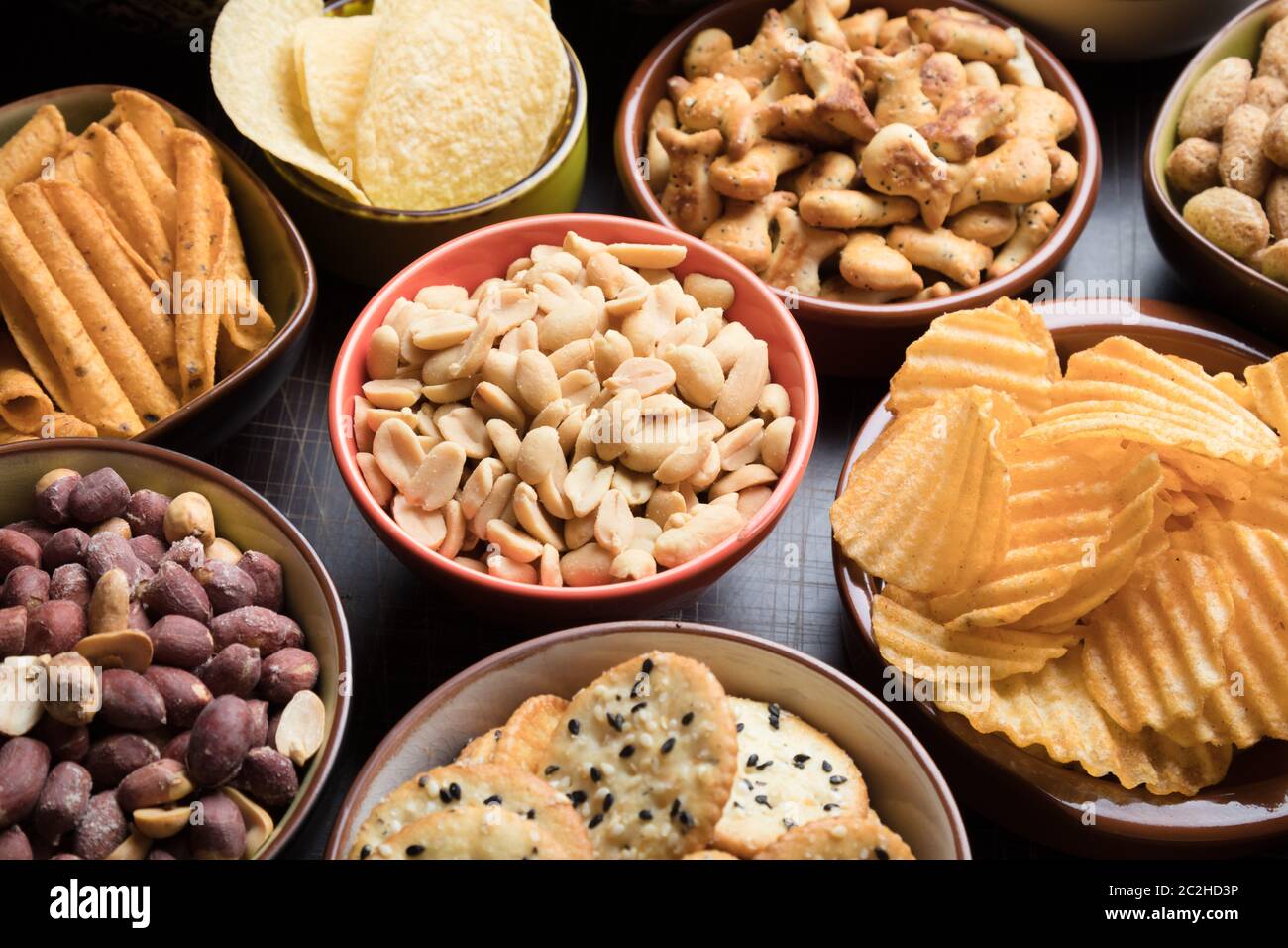 Salty snacks served as party food in ceramic bowls Stock Photo - Alamy