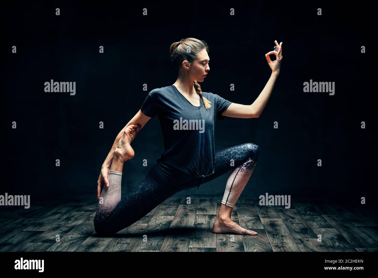 Young beautiful woman doing yoga asana one legged king pigeon pose in ...