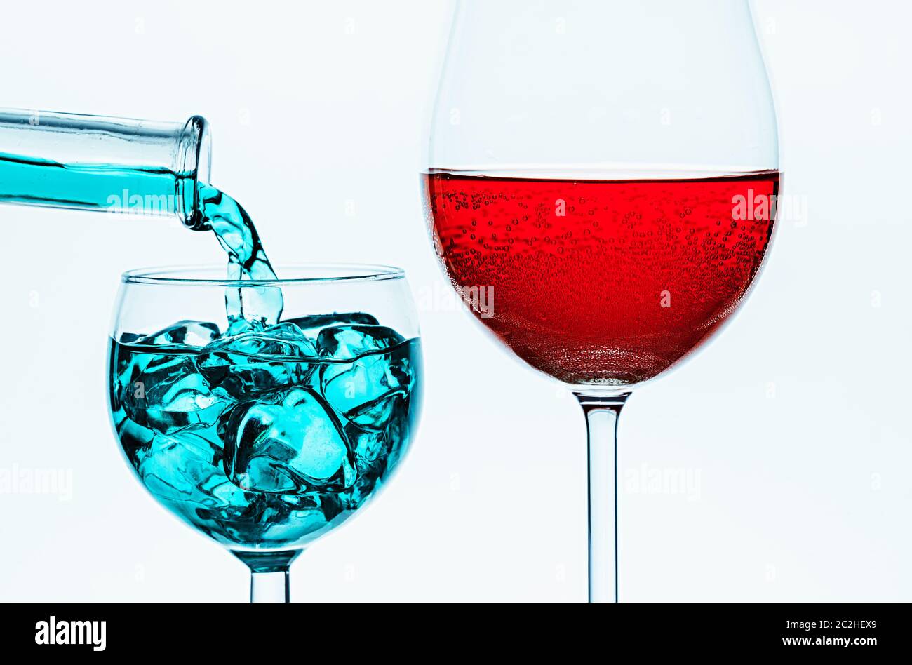 two glasses are filled with coloured liquid .Isolated on white ...
