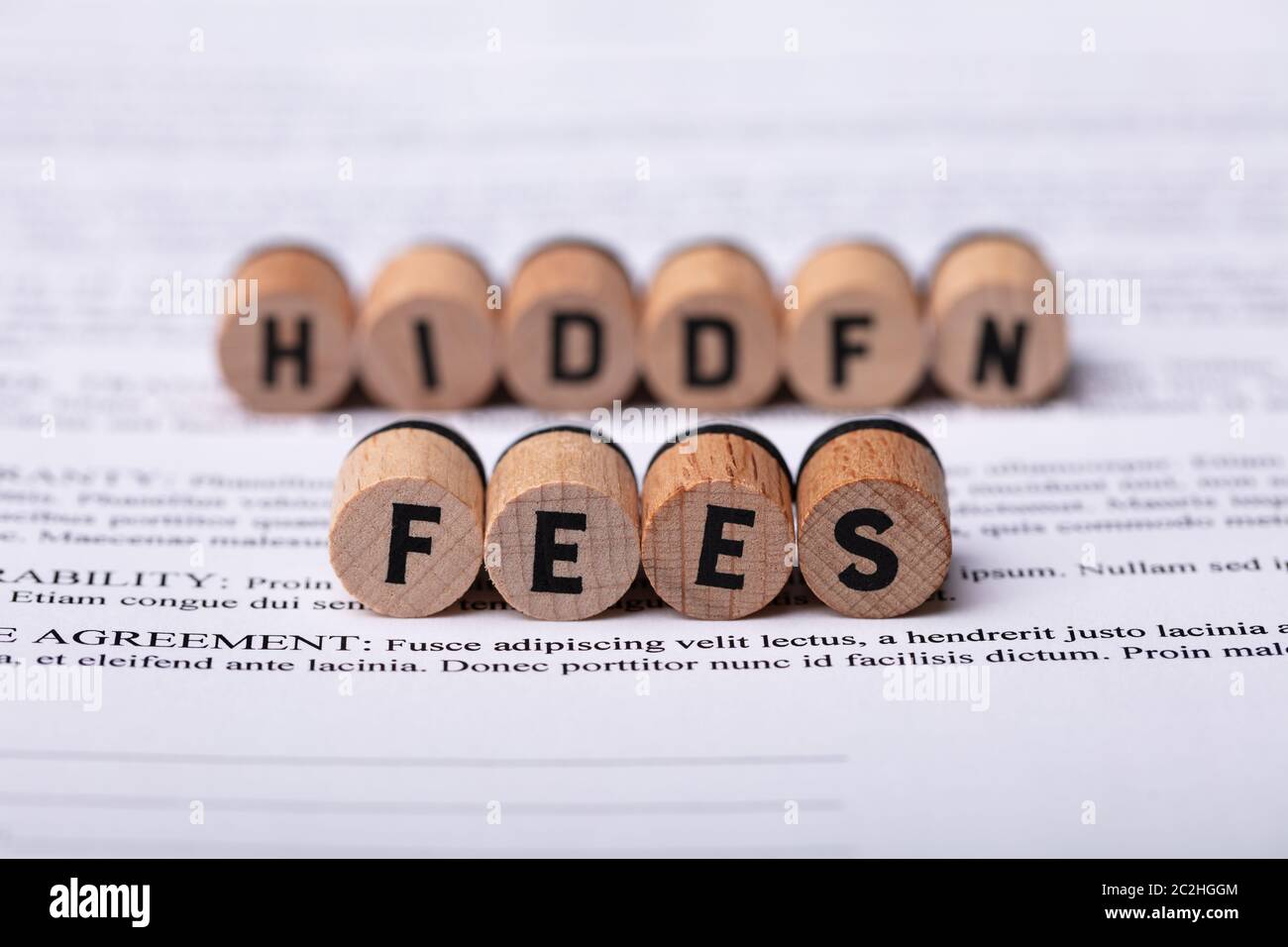 Wooden Letters Forming Hidden Fees Words On Contract Papers Stock Photo ...