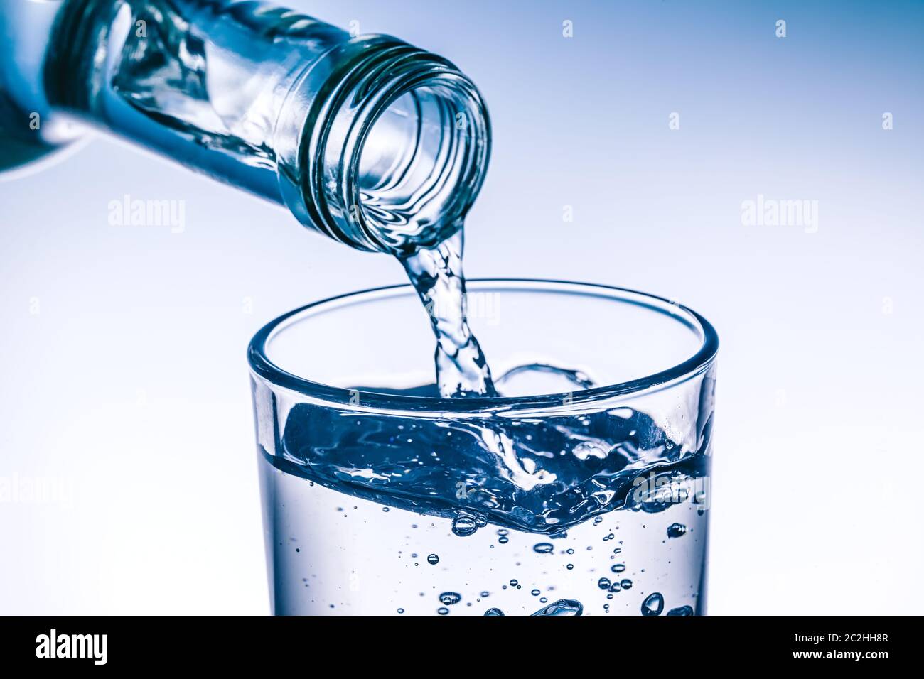 Glass is filled with clear liquid Stock Photo - Alamy