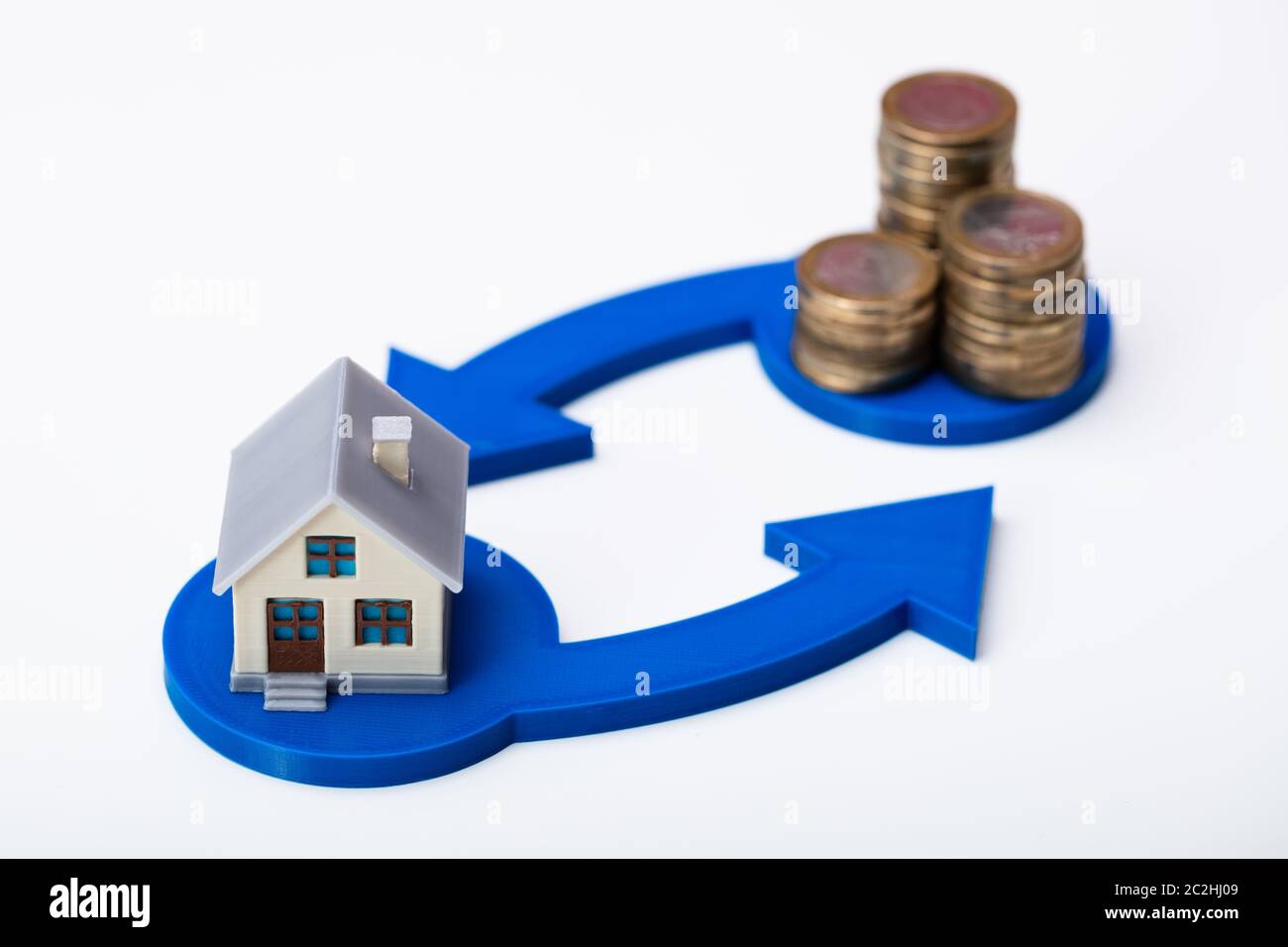 House And Stacked Coins In House Swapping Concept Stock Photo - Alamy