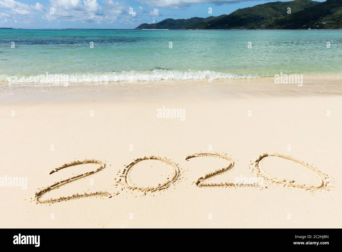 2020 Year Written On Sand Near The Sea Waves At Beach Stock Photo - Alamy