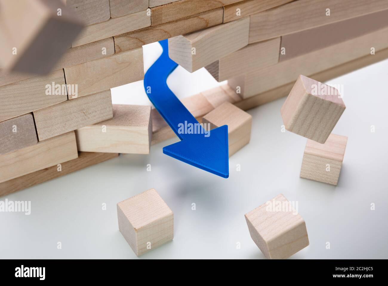 Arrow Breaking Through Wall Made Of Wooden Blocks On White Background ...