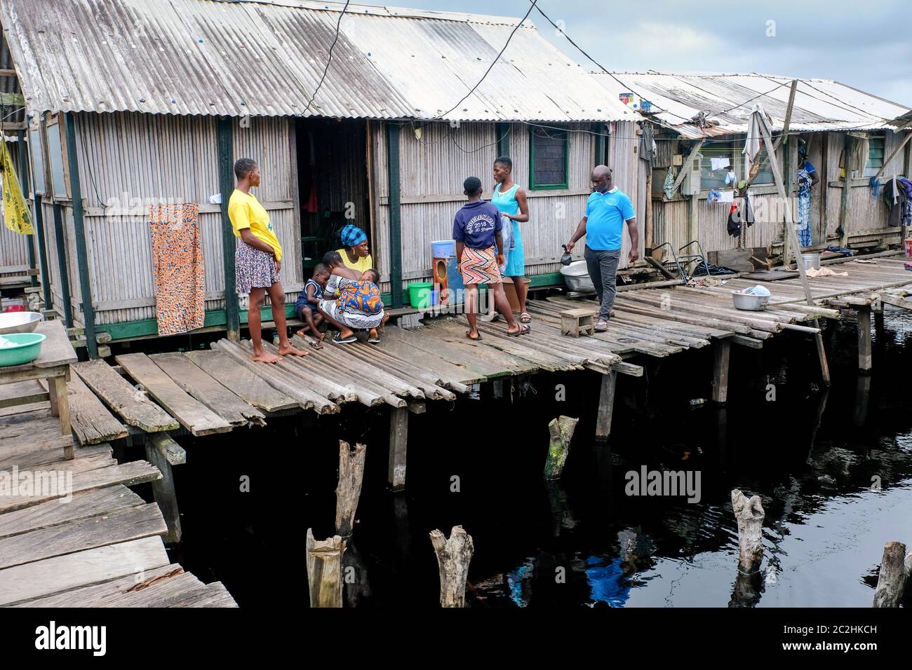 Inhabitants of the wooden huts of the stilt village of Nzulezo in Lake ...