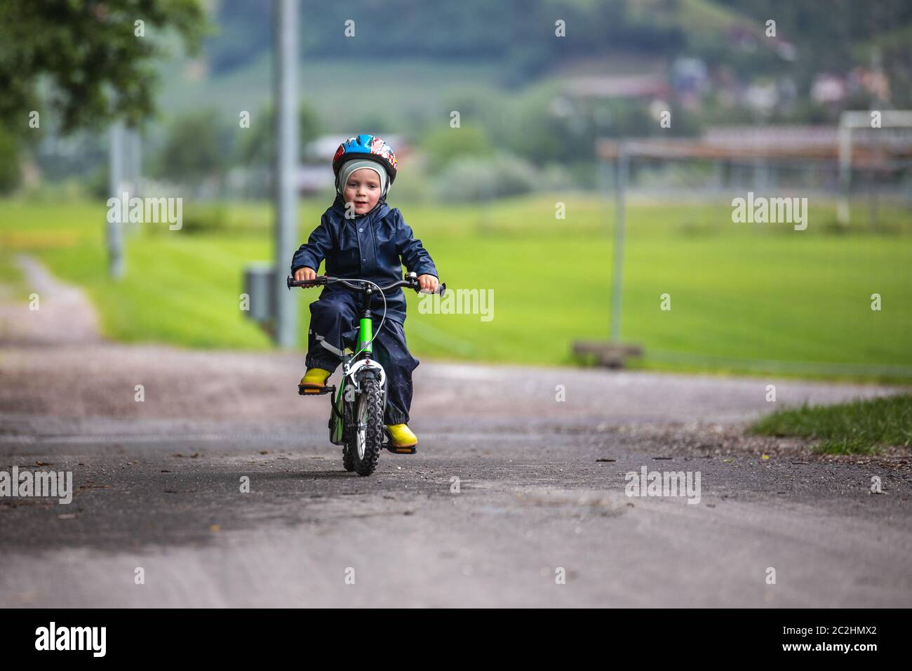 A young boy, who just learned how to ride his bike, is seen enjoying ...