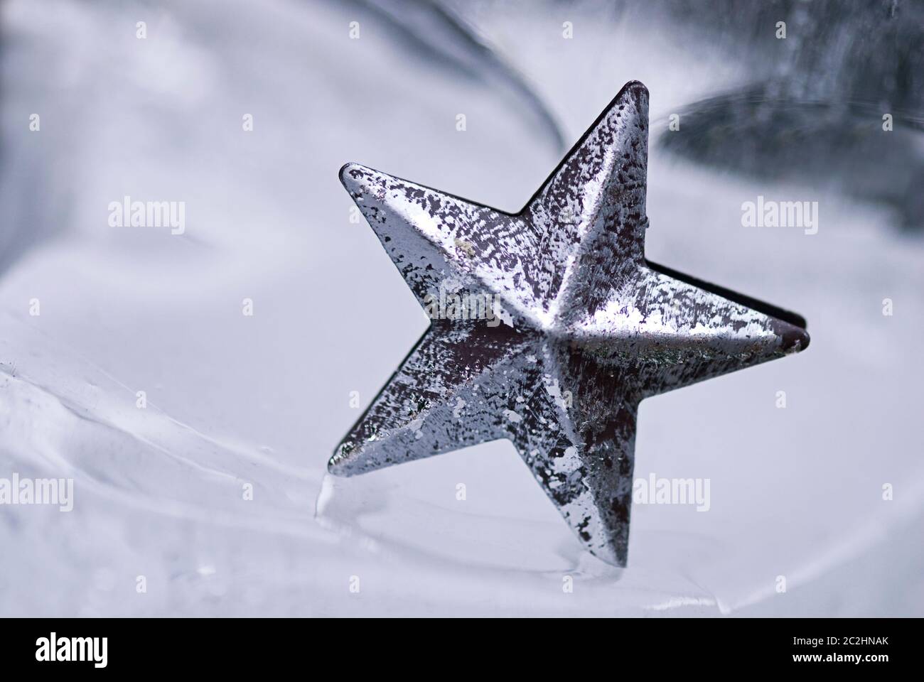 Christmas star on ice Stock Photo - Alamy