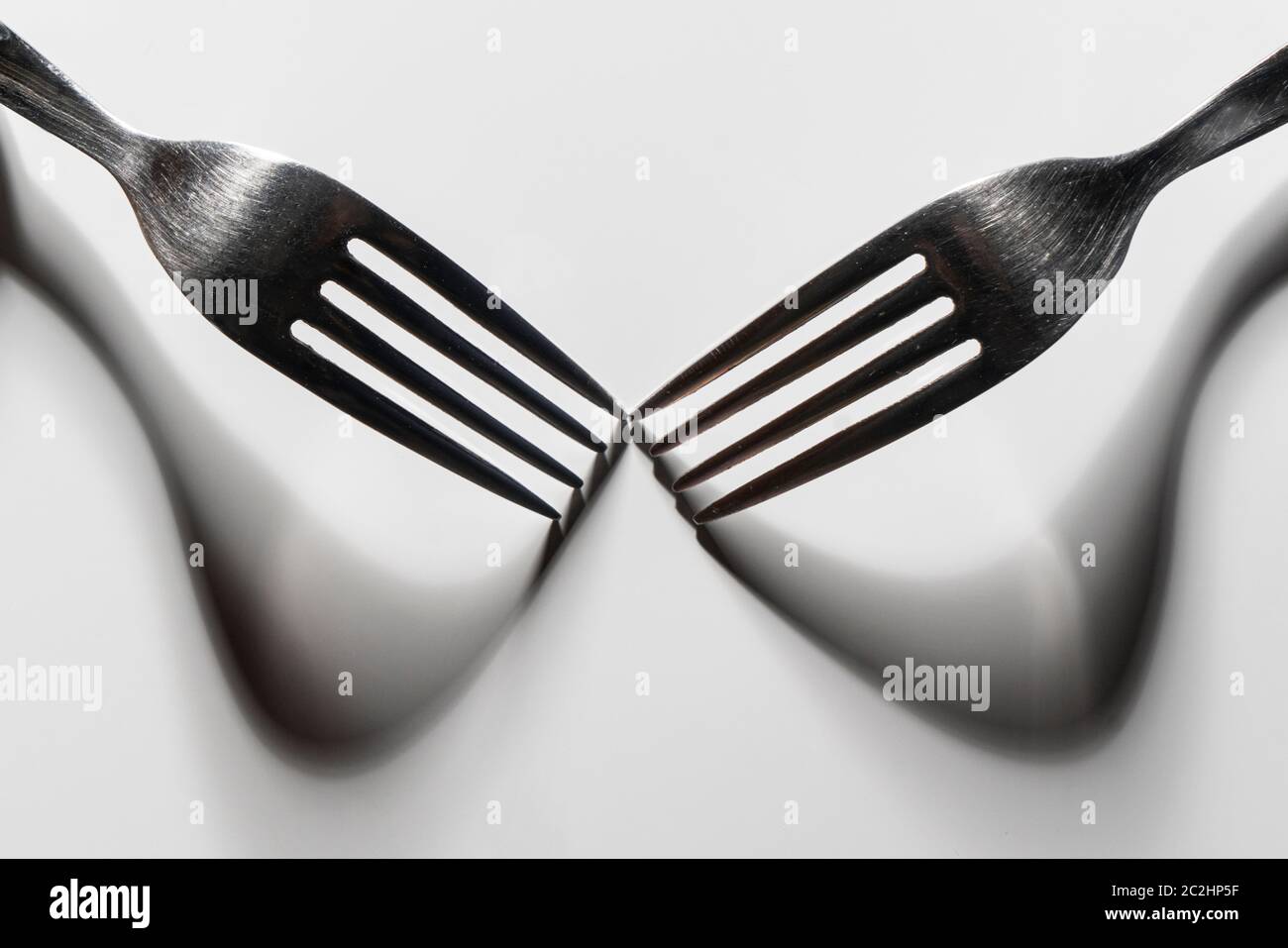 the drawing of the shadows of the forks on a white surface Stock Photo ...