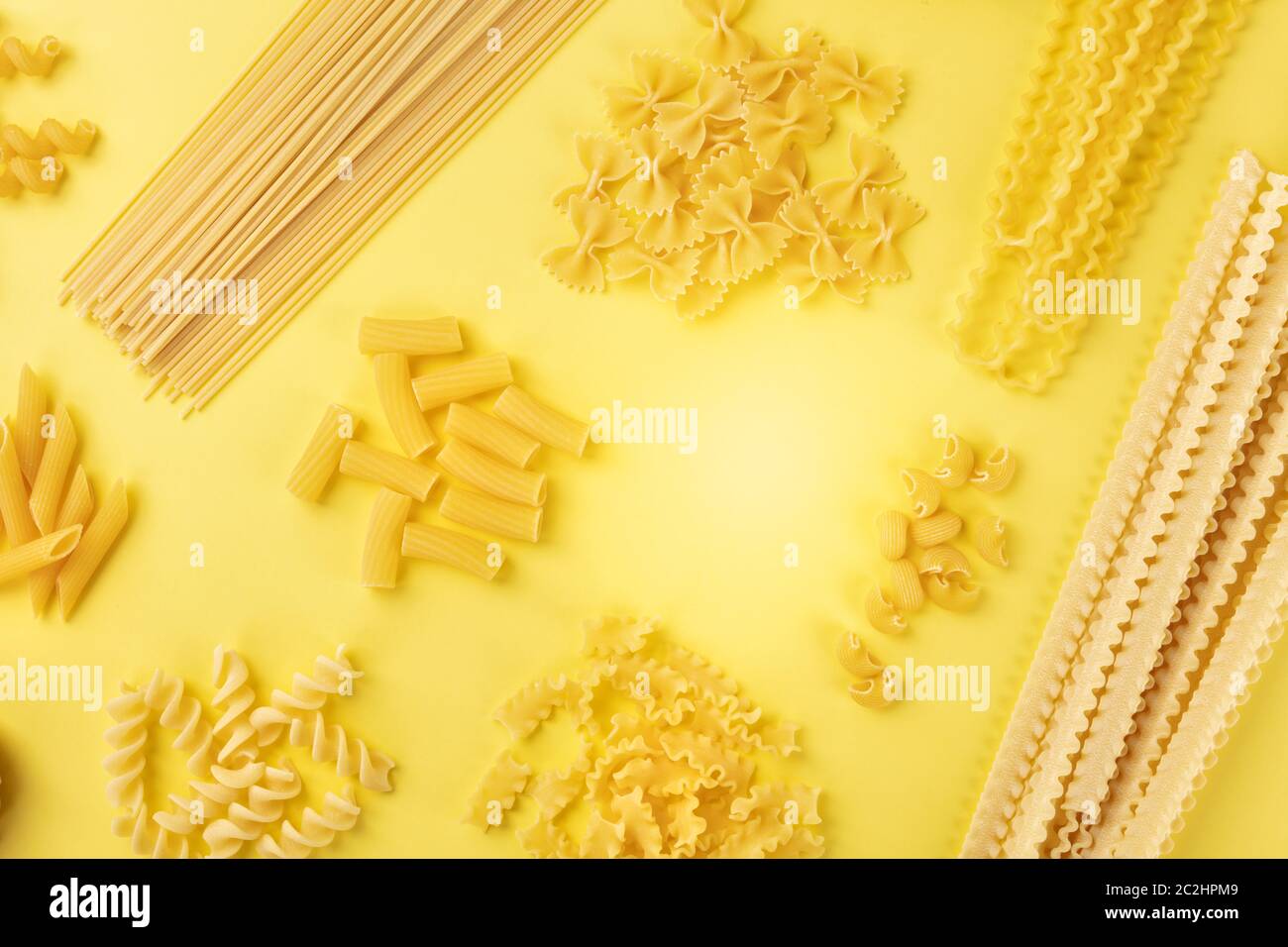 Italian pasta, flat lay banner with copy space, a top shot on a yellow ...