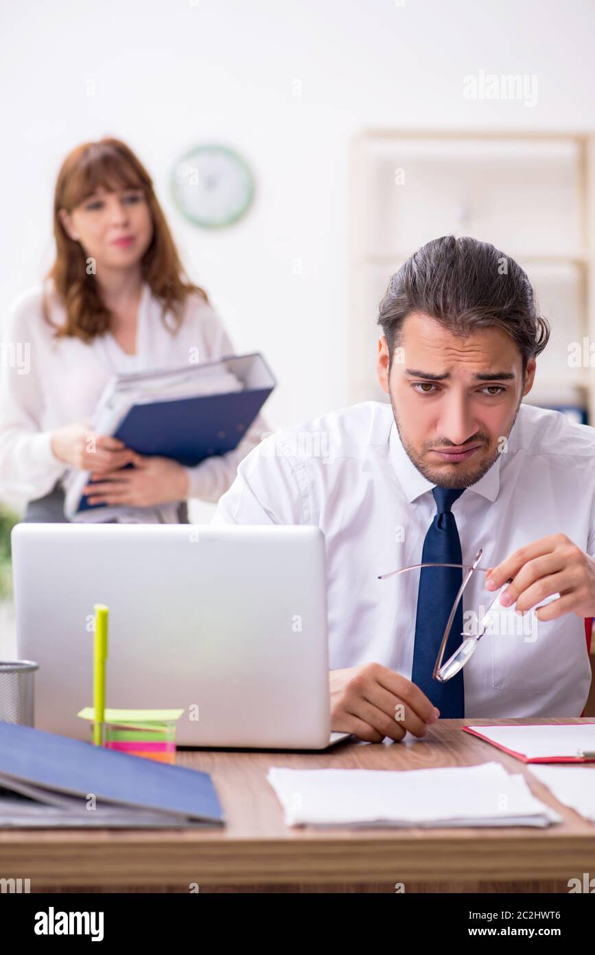 Two employees working in the office environment Stock Photo - Alamy
