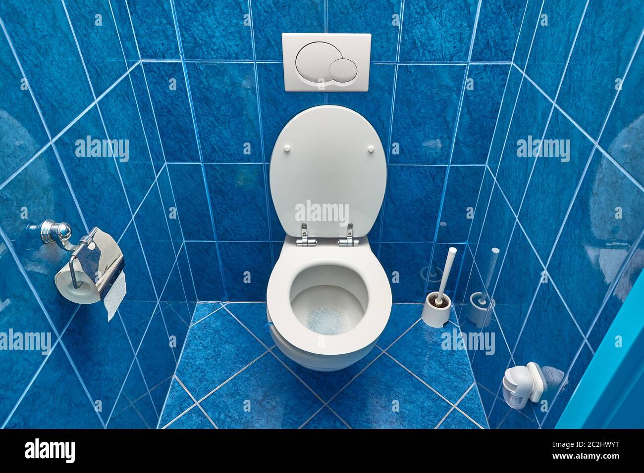 Toilet in blue tiled bathroom Stock Photo - Alamy