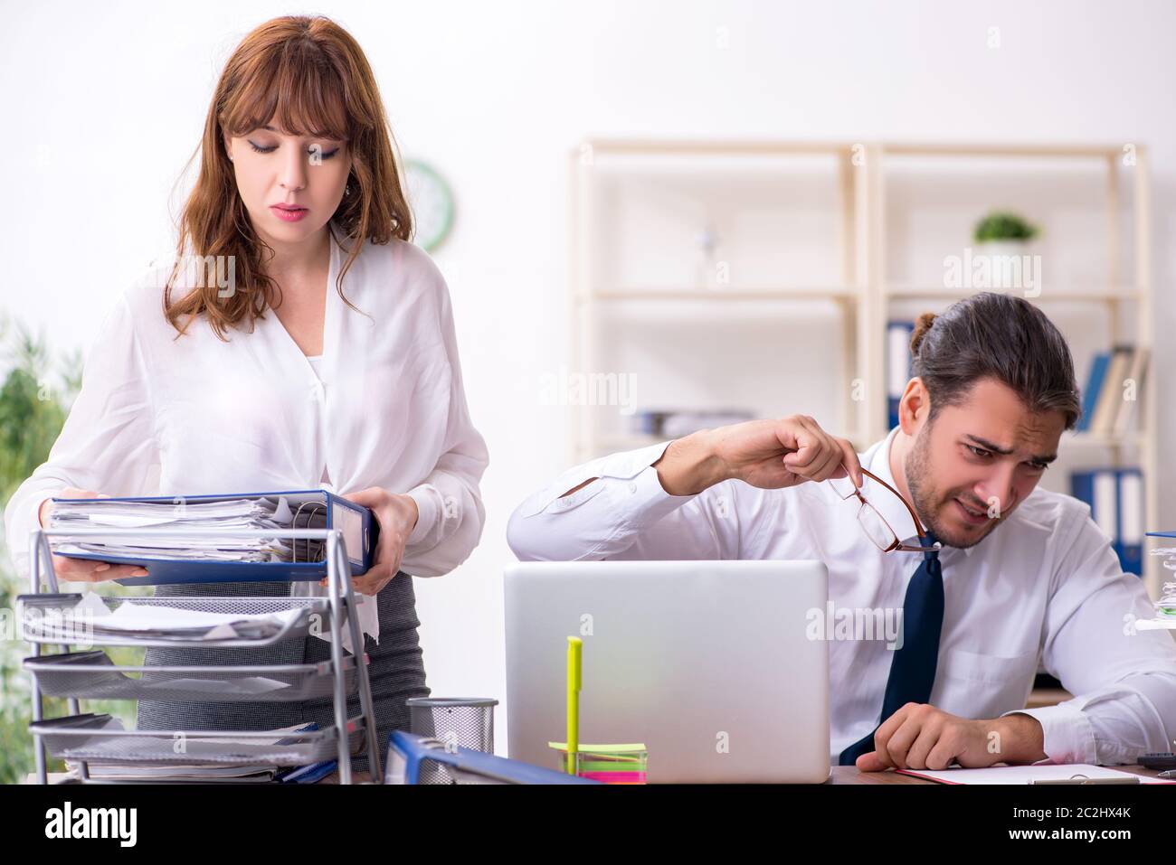 Two employees working in the office environment Stock Photo - Alamy