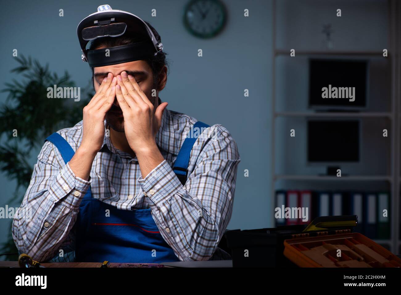 Young technician repairing computer in workshop at night Stock Photo ...