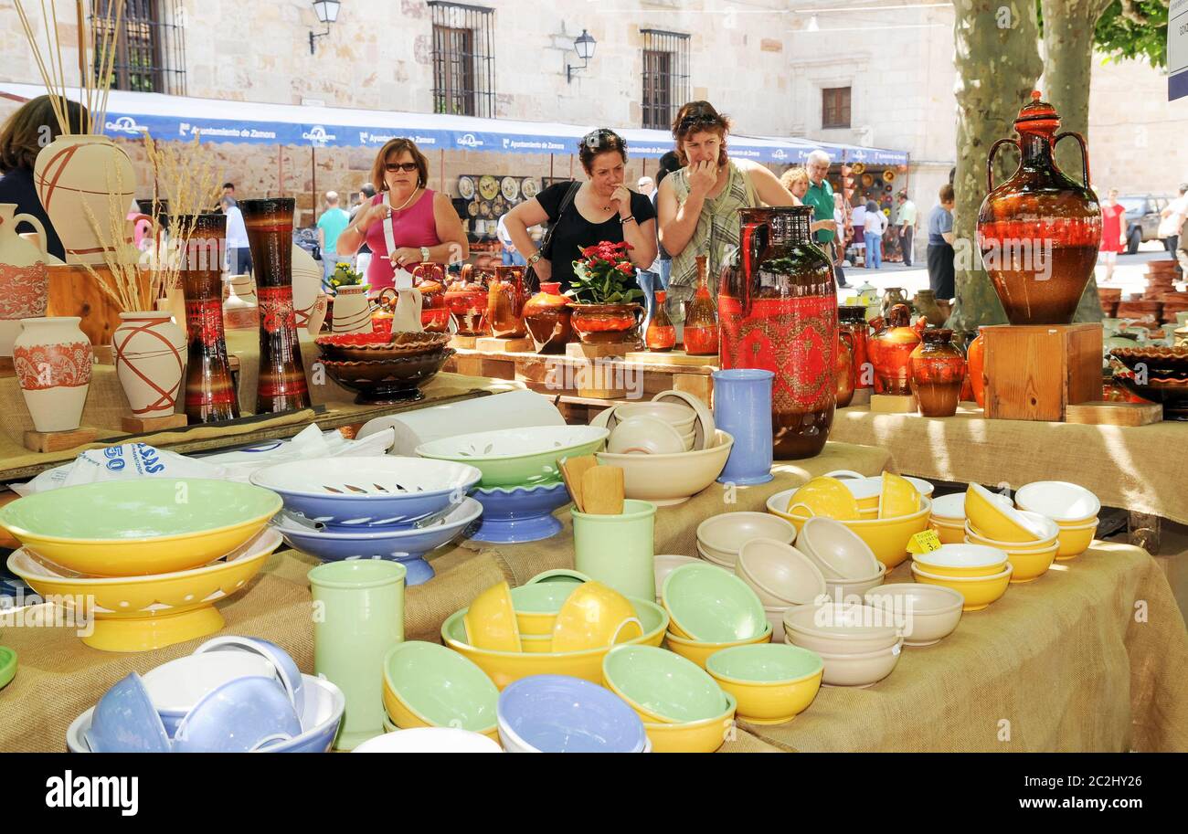 Porcelain bowls and objects at a stall at an outdoor pottery fair in ...