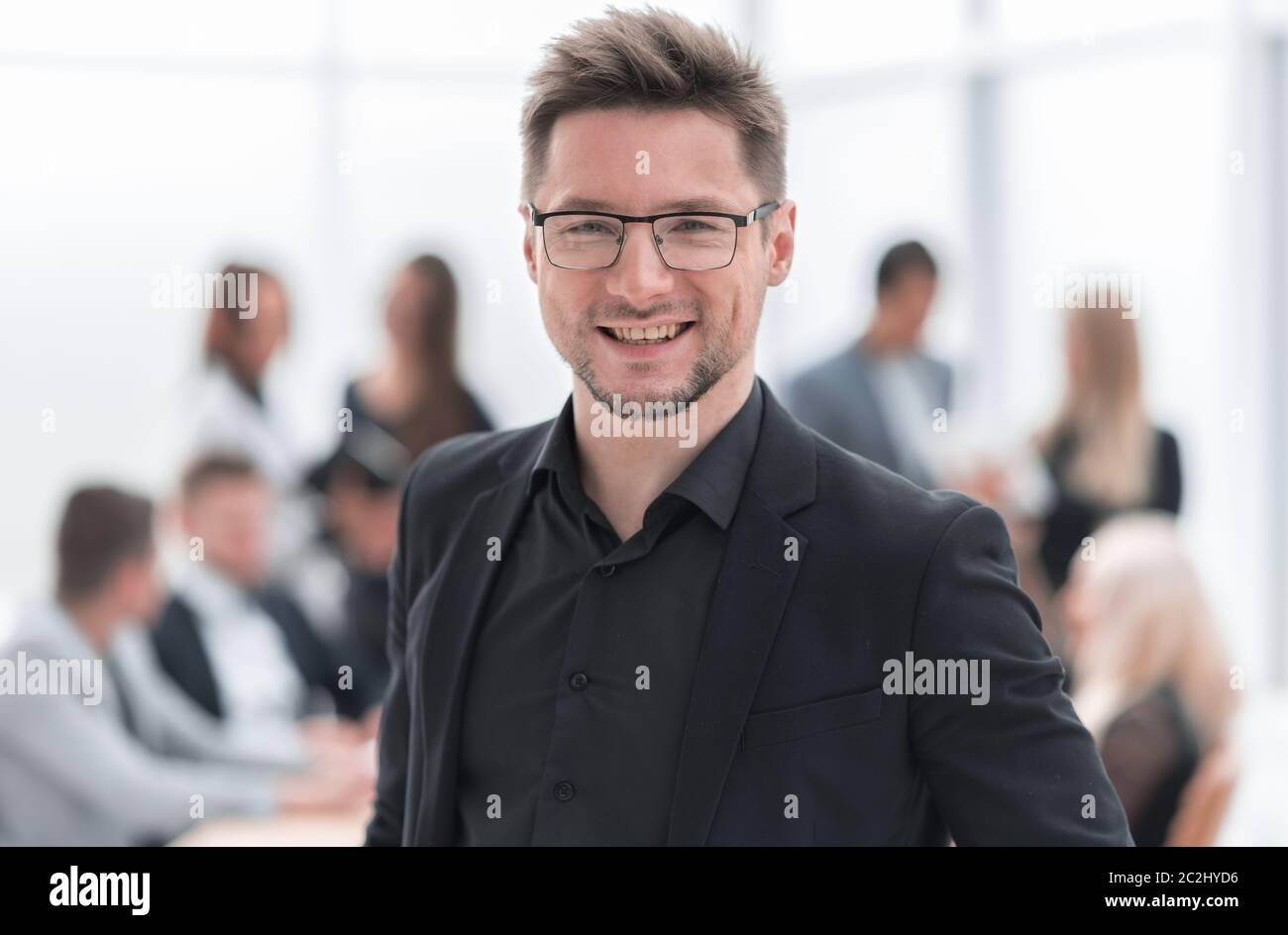close up. ambitious young businessman looking at you Stock Photo - Alamy
