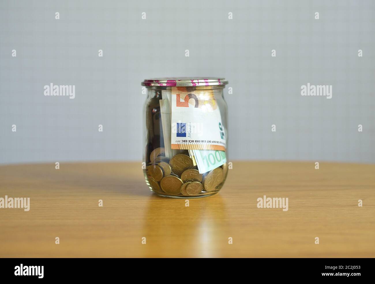 Saving Euro Money In Glass Jar Stock Photo - Alamy