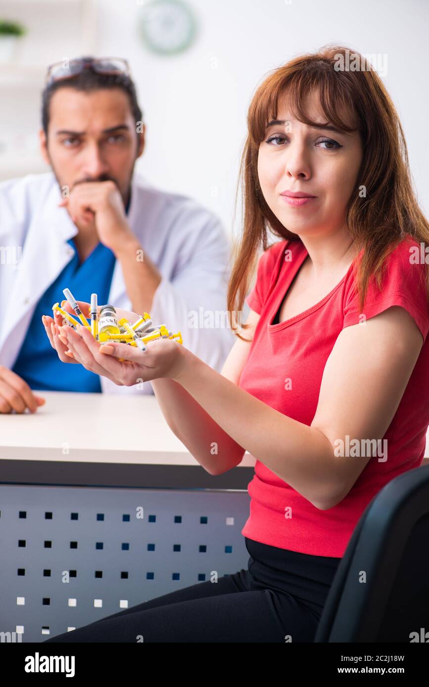 Female diabetic patient visiting young doctor Stock Photo - Alamy