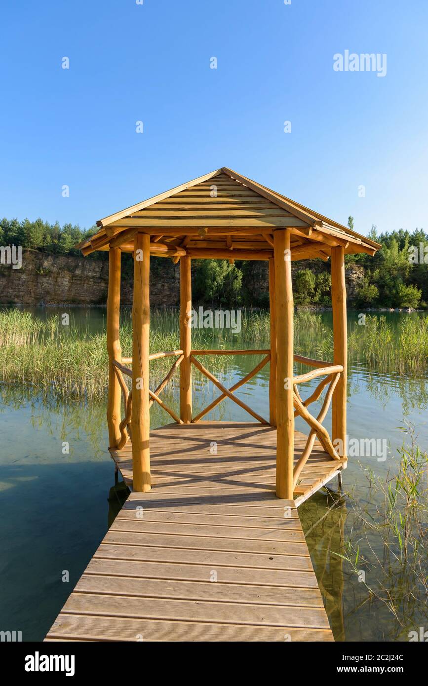 Wooden bower on the pond in an old quarry in Grodek park in Jaworzno ...
