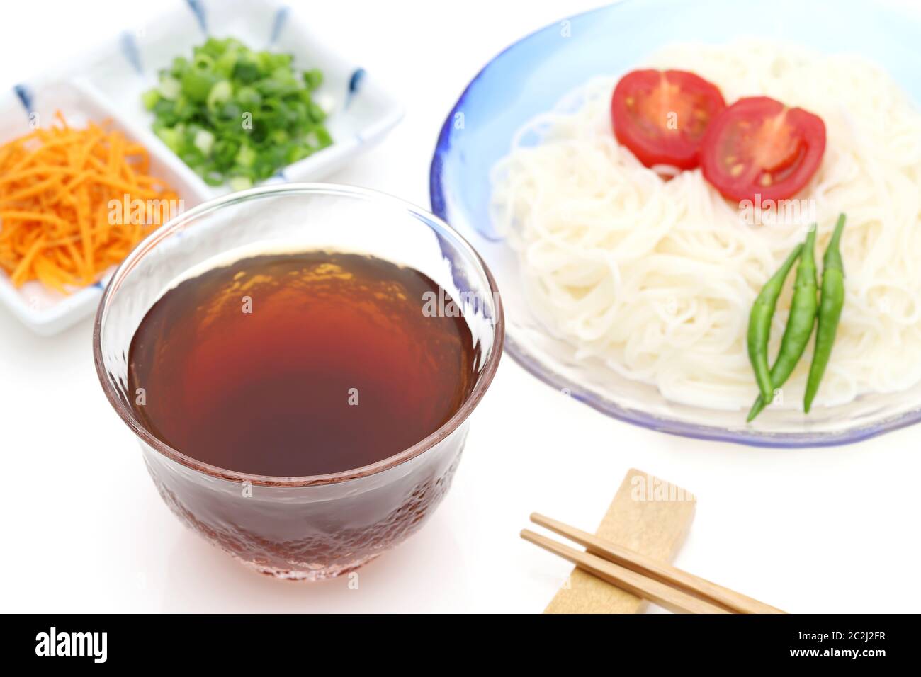 Japanese somen noodles in a glass dish with soy sauce on white ...