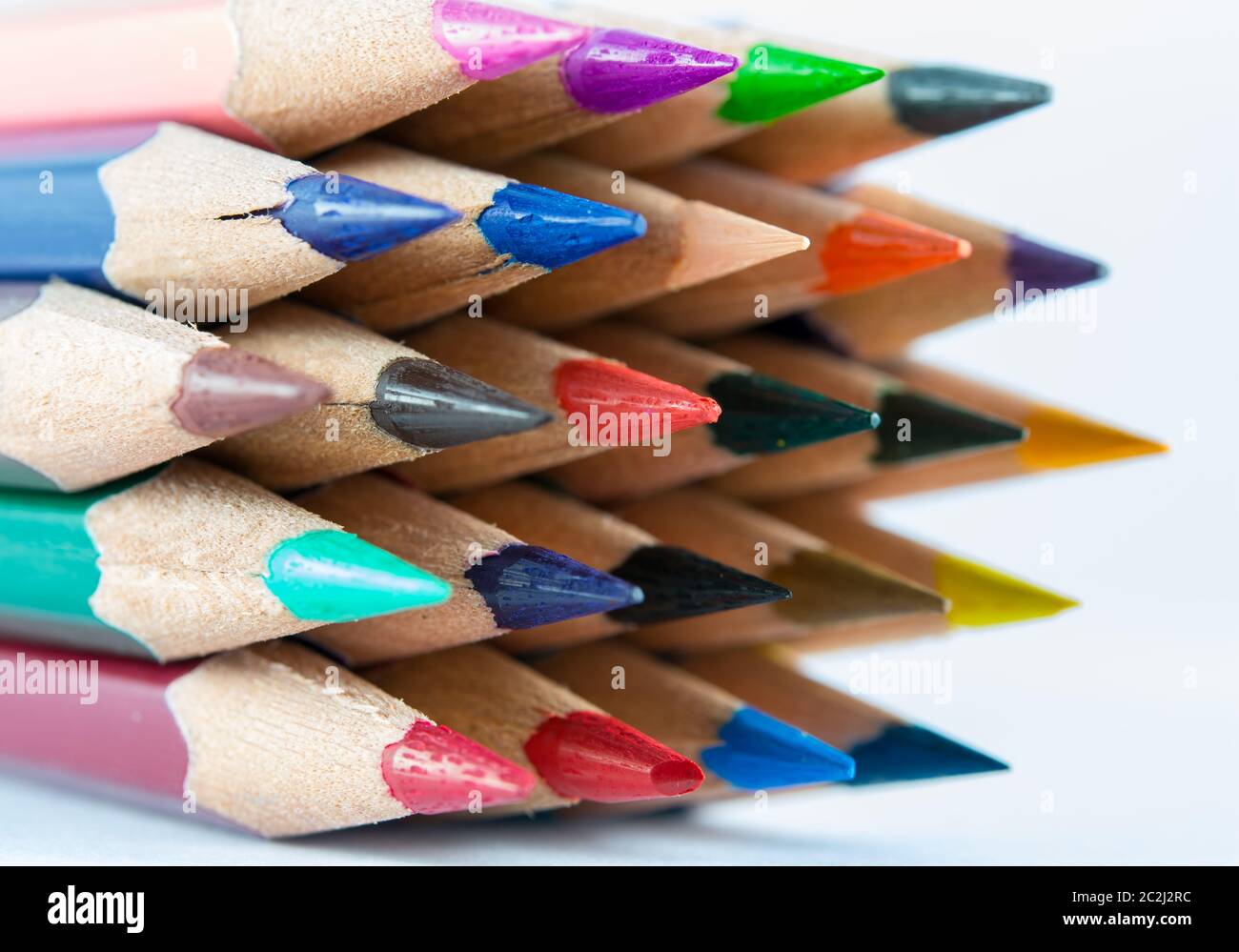 pointed color pencils and a white background Stock Photo - Alamy