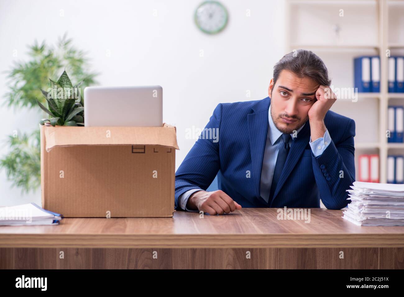 Young man being fired from his workplace Stock Photo - Alamy