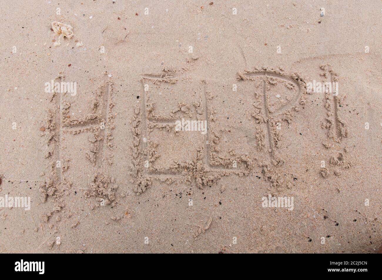 Help! stranded on the beach write sand Stock Photo - Alamy