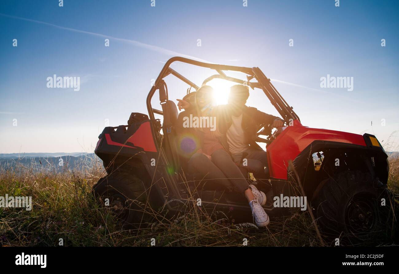 young couple driving a off road buggy car Stock Photo - Alamy