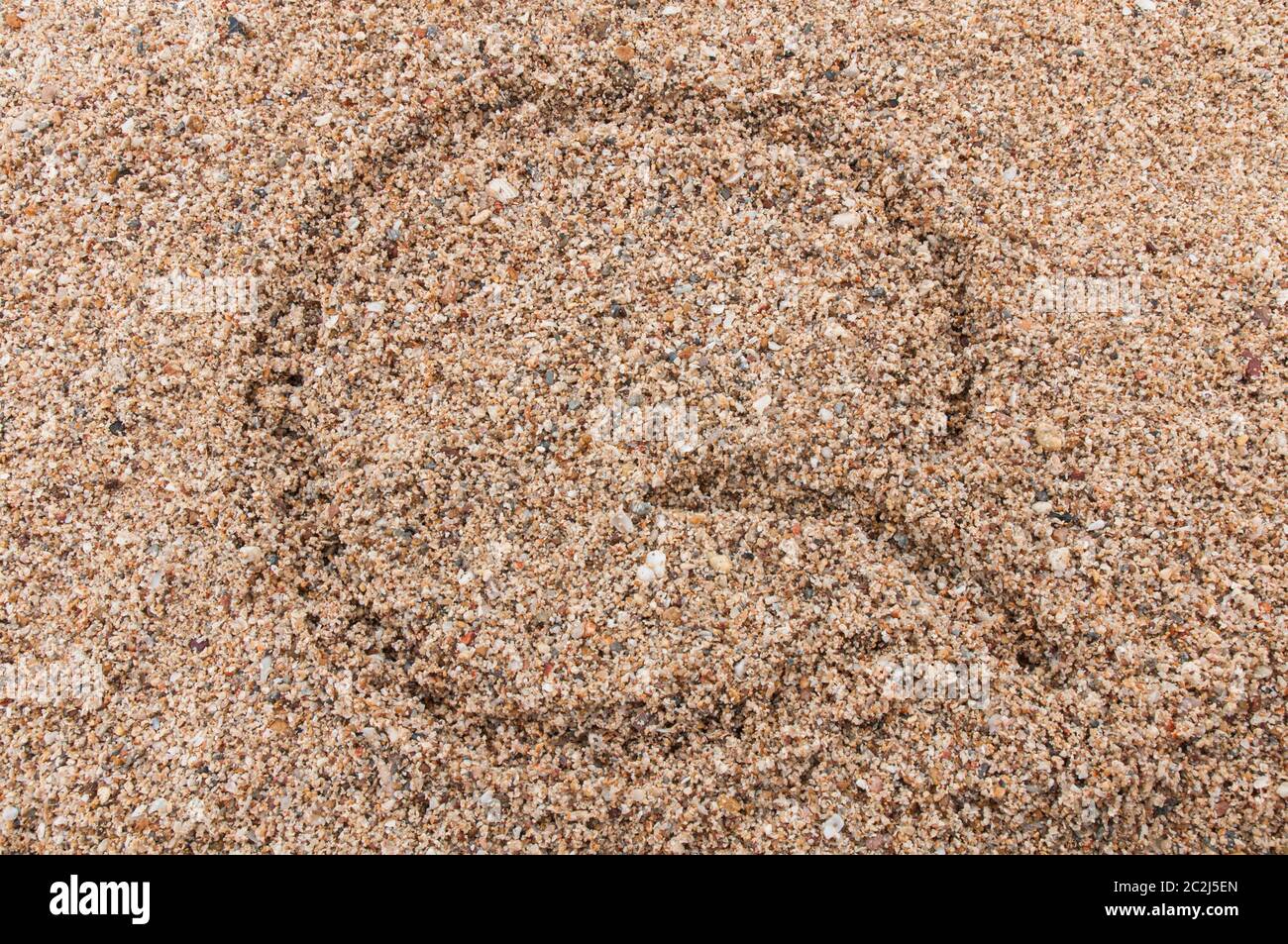Character Q of the alphabet writing on the sand Stock Photo - Alamy