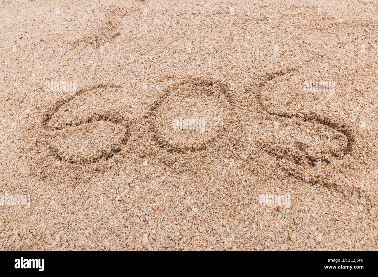 Sos written in the sand hi-res stock photography and images - Alamy