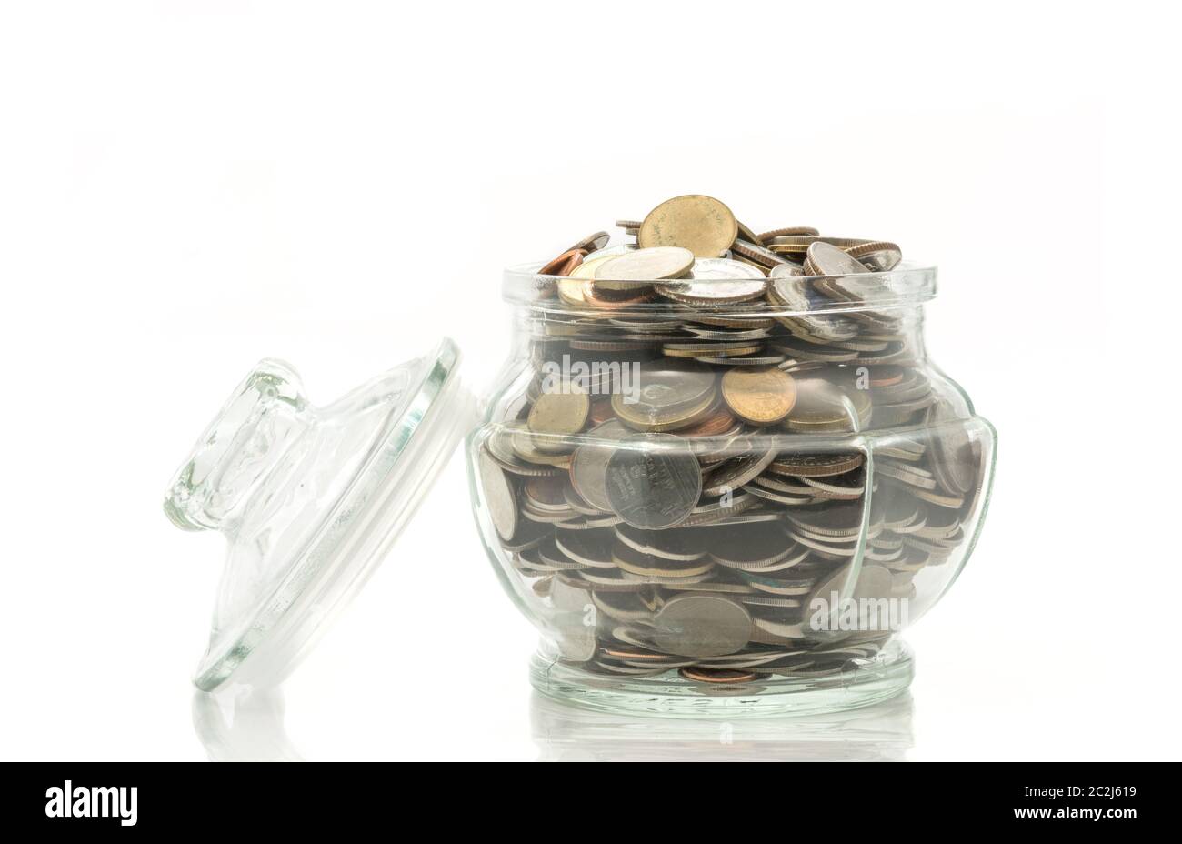 Bath coins in a glass jar with lid on white background Stock Photo - Alamy