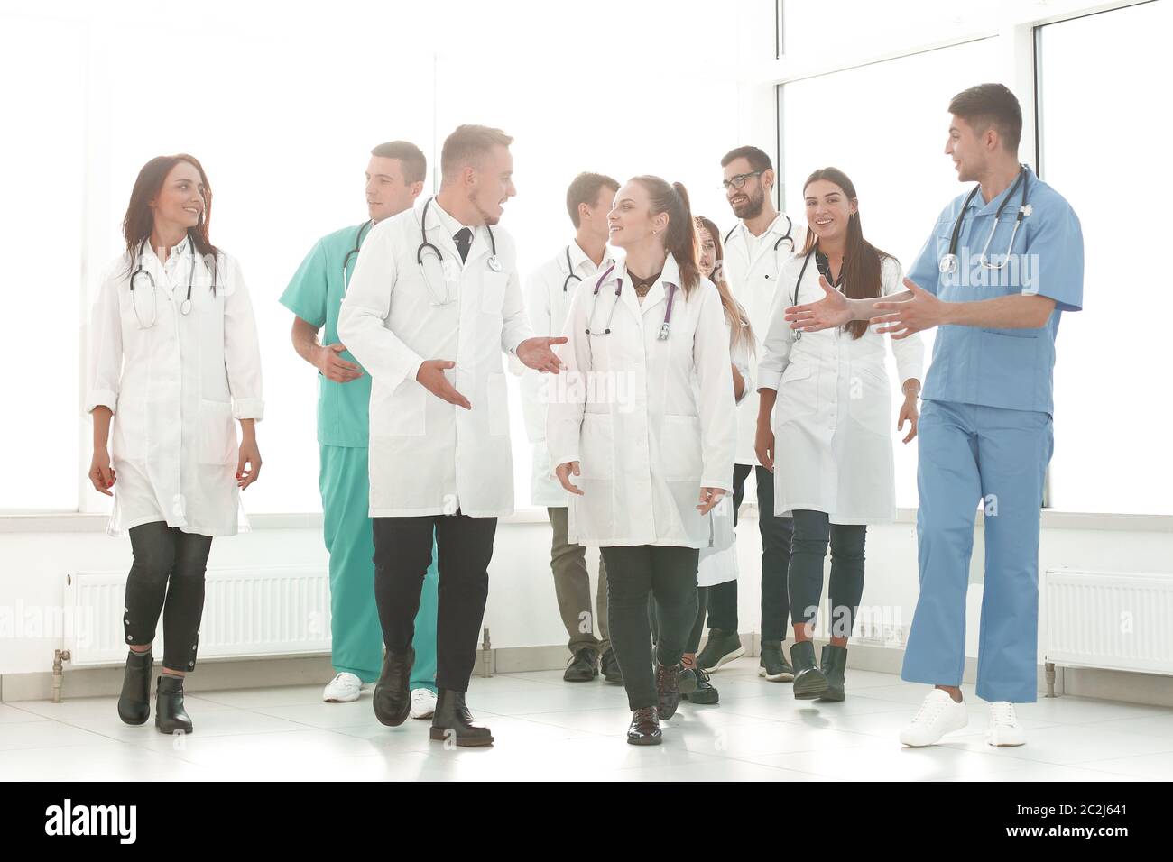 Healthcare professionals walk through hi-res stock photography and ...