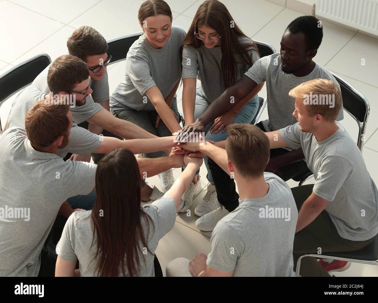 young business people making a tower out of their hands Stock Photo - Alamy