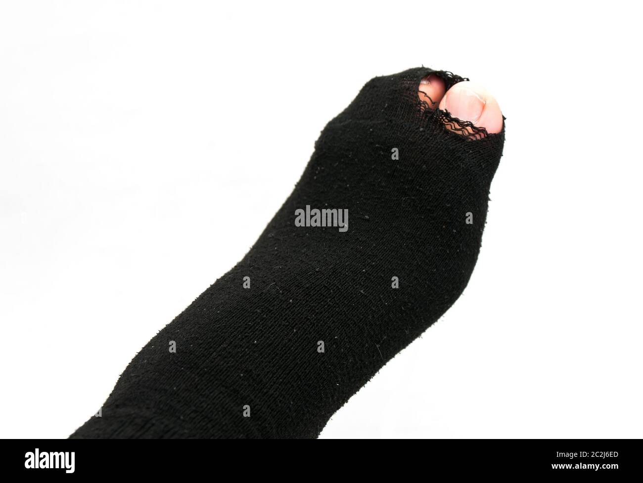 Foot in old sock and torn on white background Stock Photo - Alamy