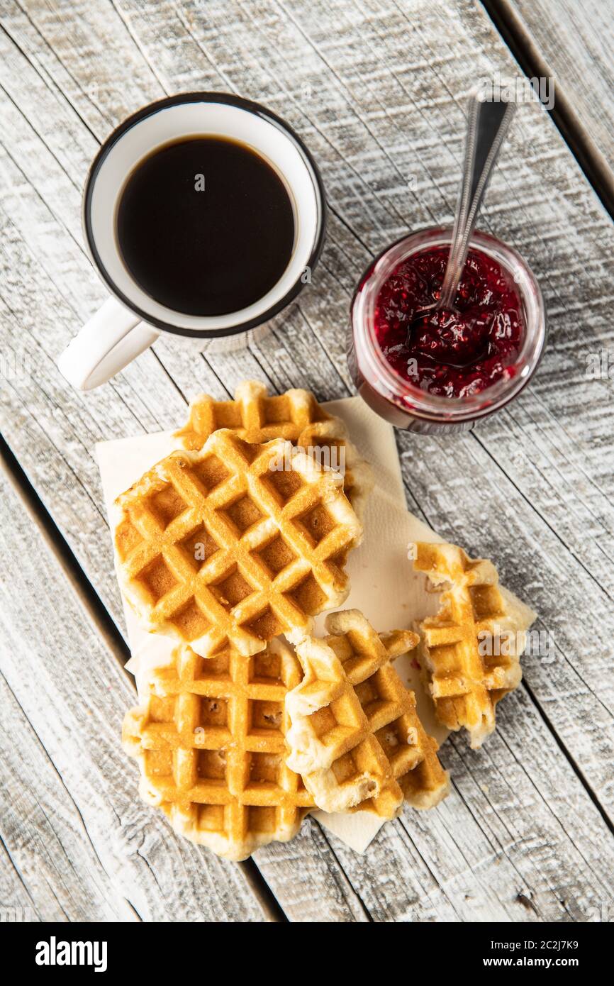 Tasty sweet waffles with raspberry jam and tea cup. Top view Stock ...