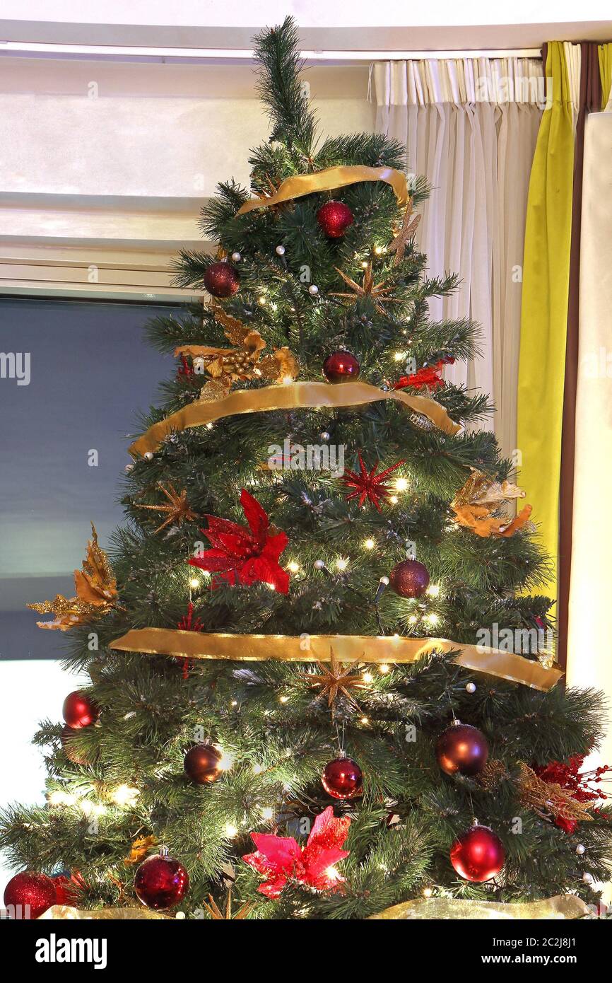 Christmas tree with colorful ornaments inside modern interior Stock ...