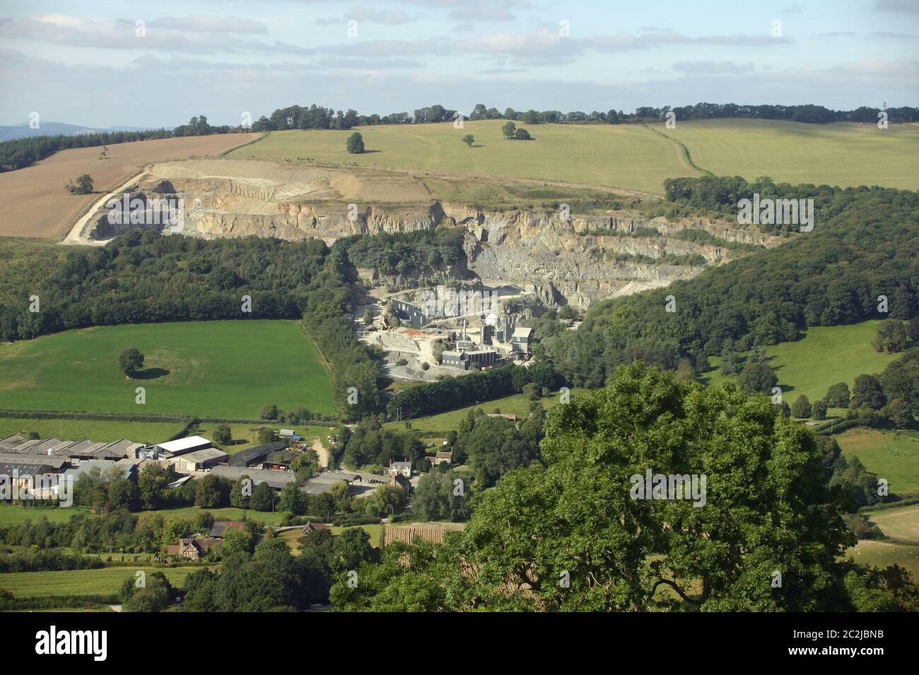 Quarry on a hill in an English landscape with fields, trees on the ...