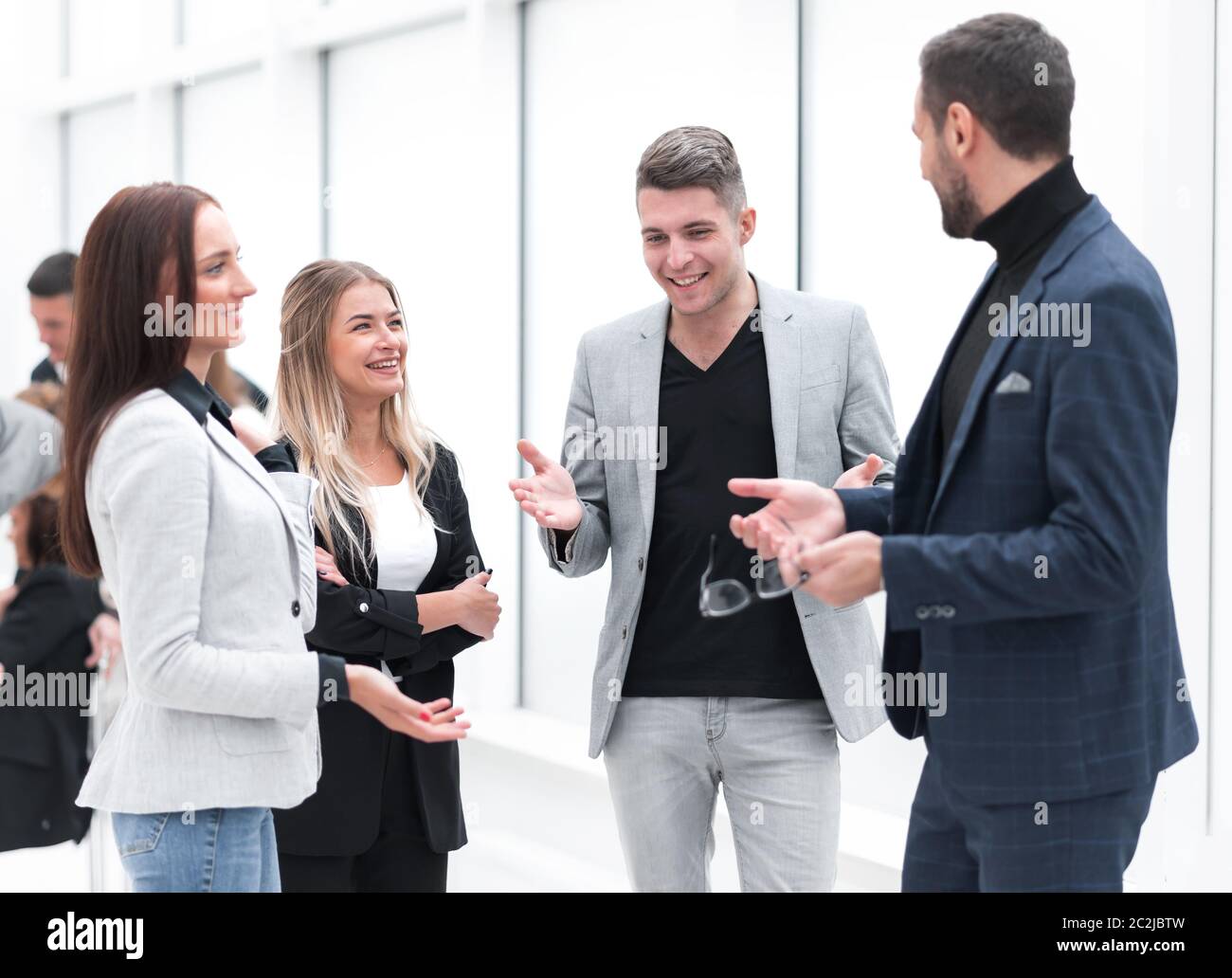 Manager telling about something to young employees Stock Photo - Alamy