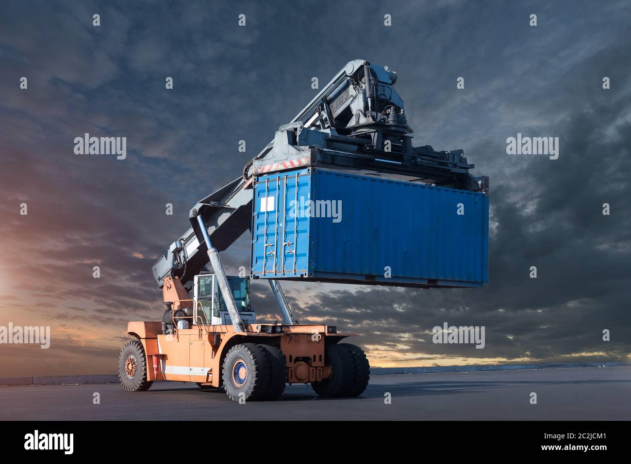 Forklift handling container box loading at Docks Stock Photo - Alamy